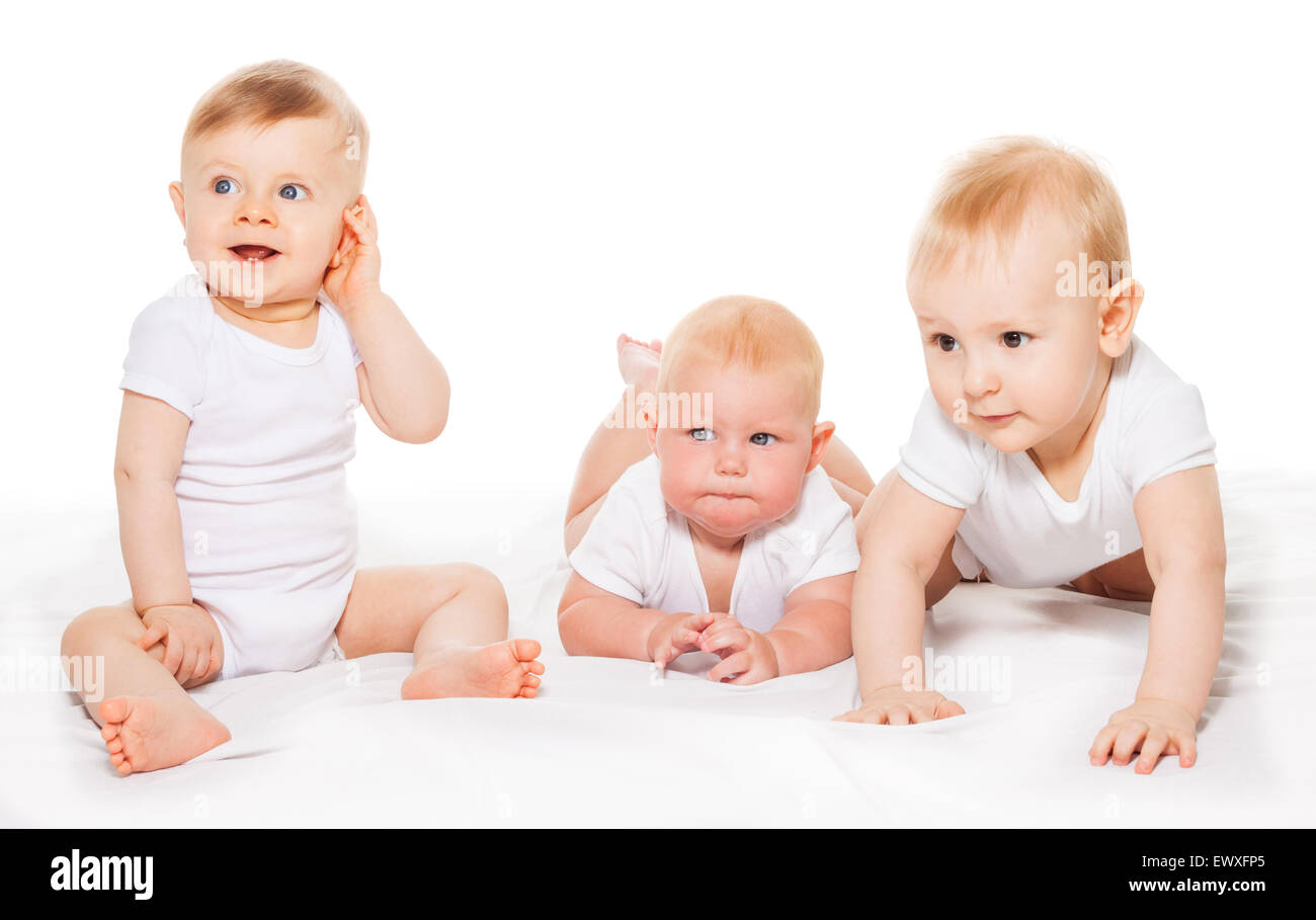 Three looking babies crawl and sit on blanket Stock Photo - Alamy