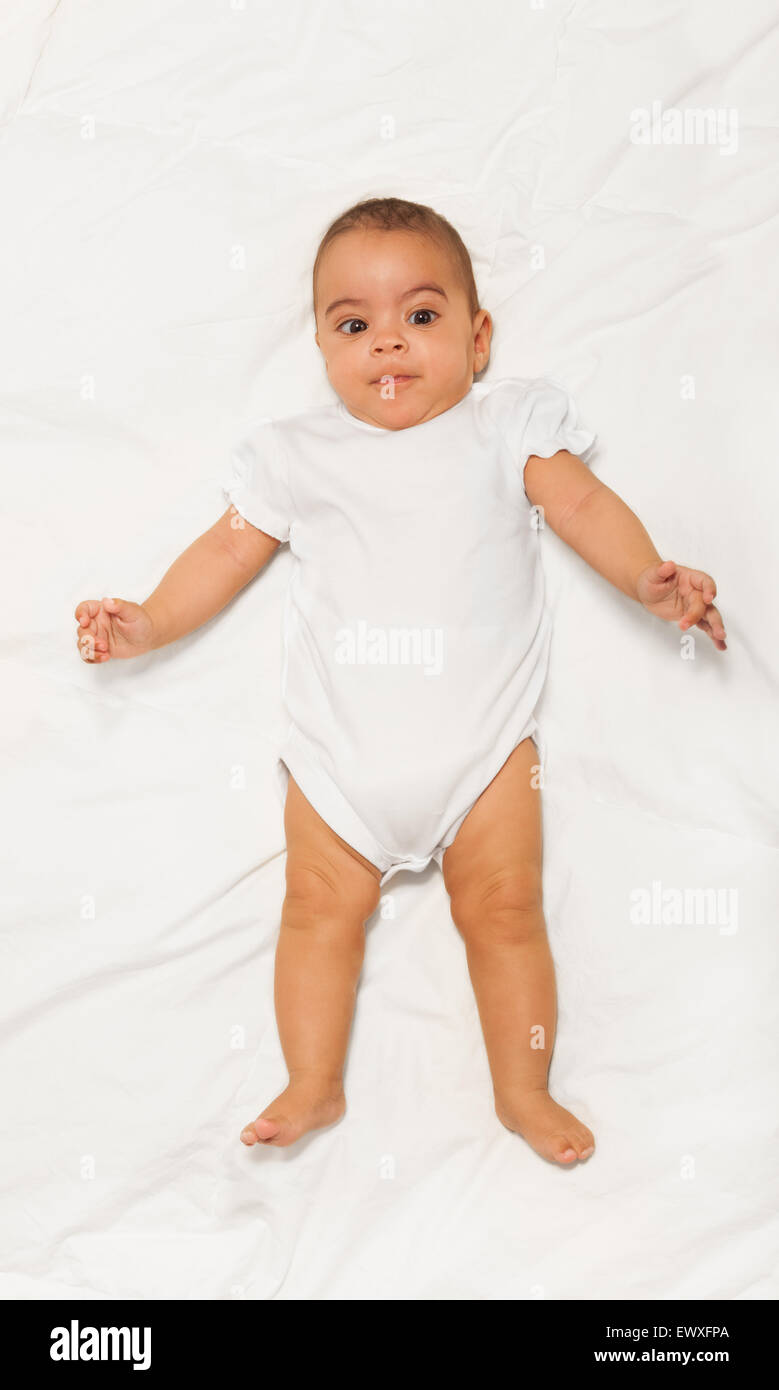 Chubby African small baby wearing white babygro Stock Photo - Alamy