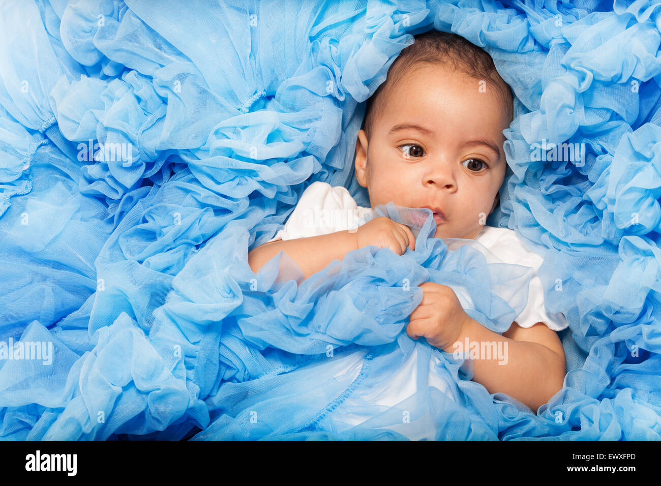 Chubby African small baby laying on the blue cloth Stock Photo - Alamy