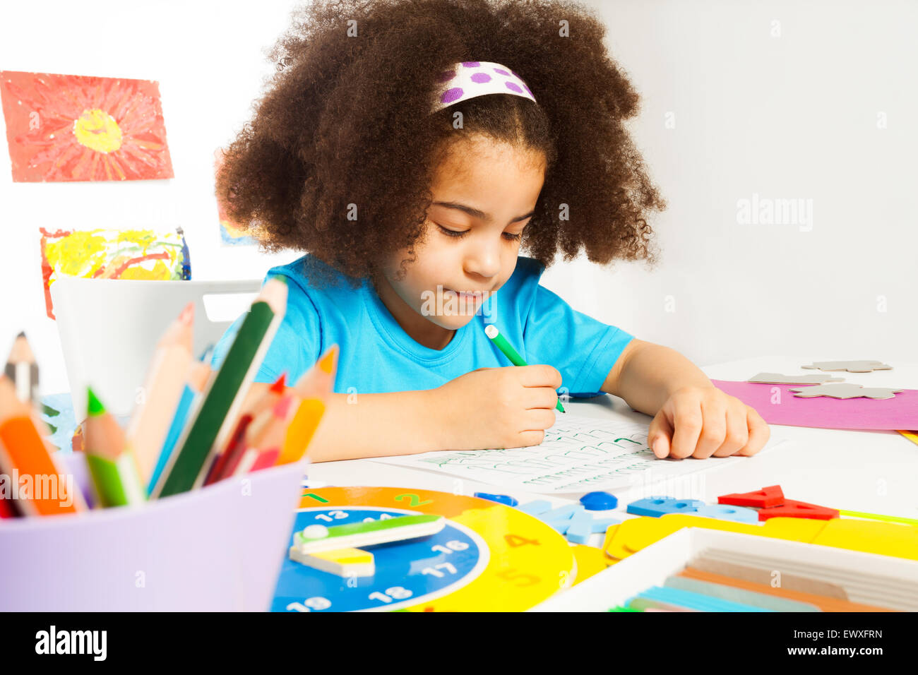 Small African girl writing letters on the paper Stock Photo - Alamy