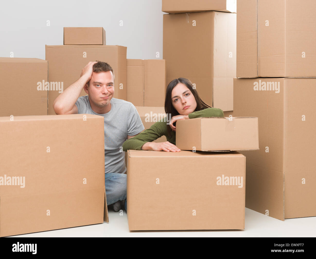 Sad woman packing boxes hi-res stock photography and images - Alamy