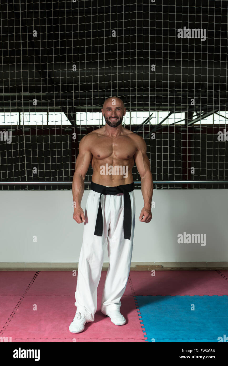 Male Martial Arts Instructor Preparing For Class - Warming Up and ...
