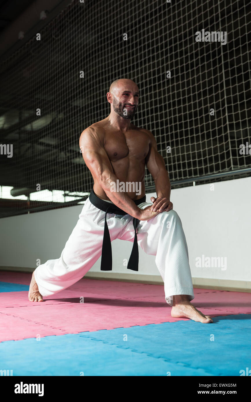 Male Martial Arts Instructor Preparing For Class - Warming Up and ...