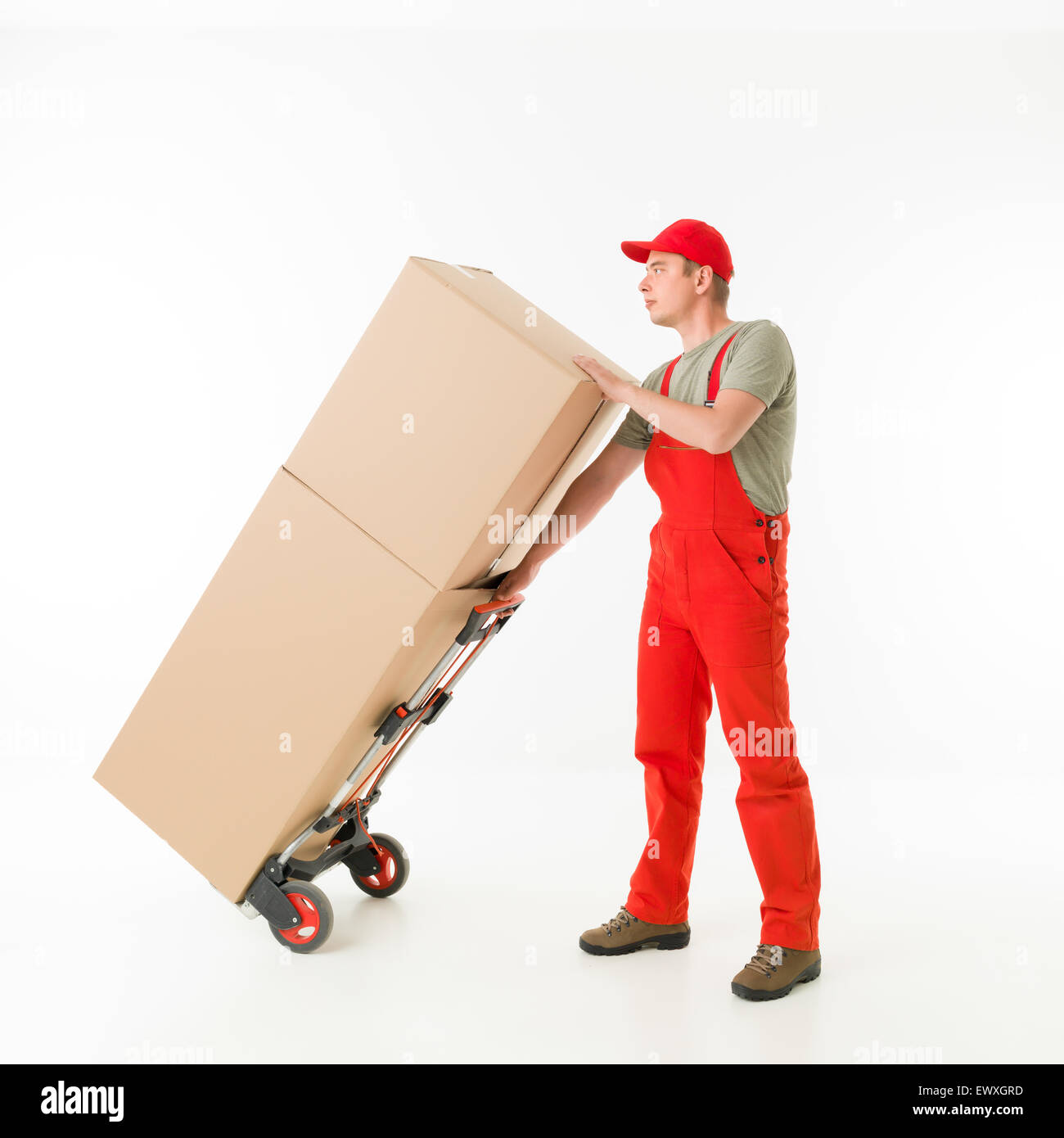 delivery man holding push cart loaded with cardboard boxes, on white ...