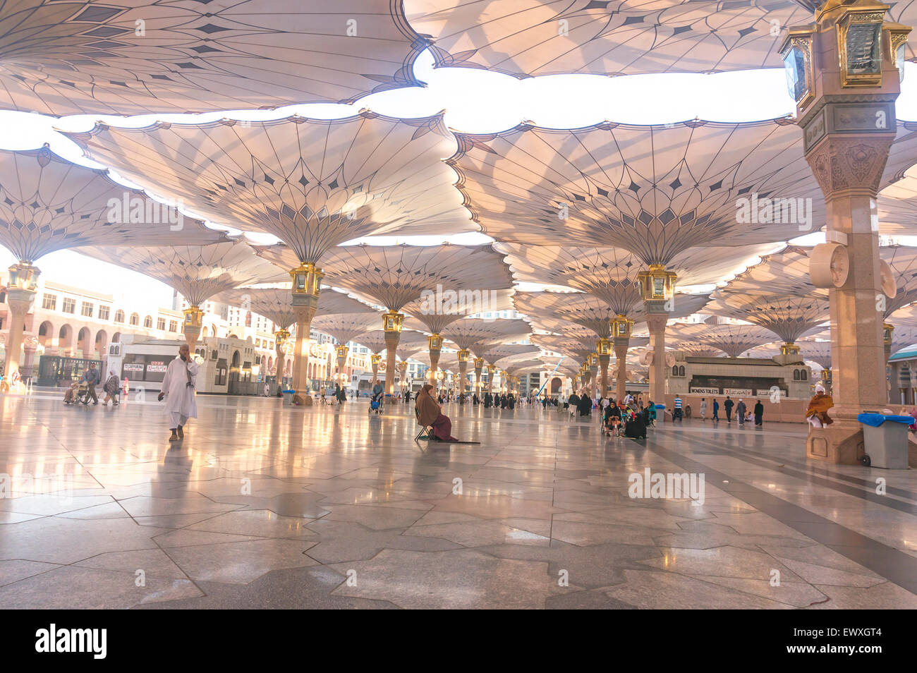 MEDINA, SAUDI ARABIA - MARCH 06, 2015 : Pilgrims walk underneath giant ...