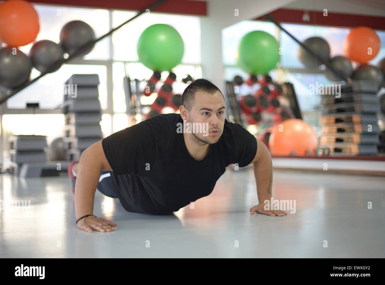 Young Man Doing Pushups at gym Stock Photo - Alamy