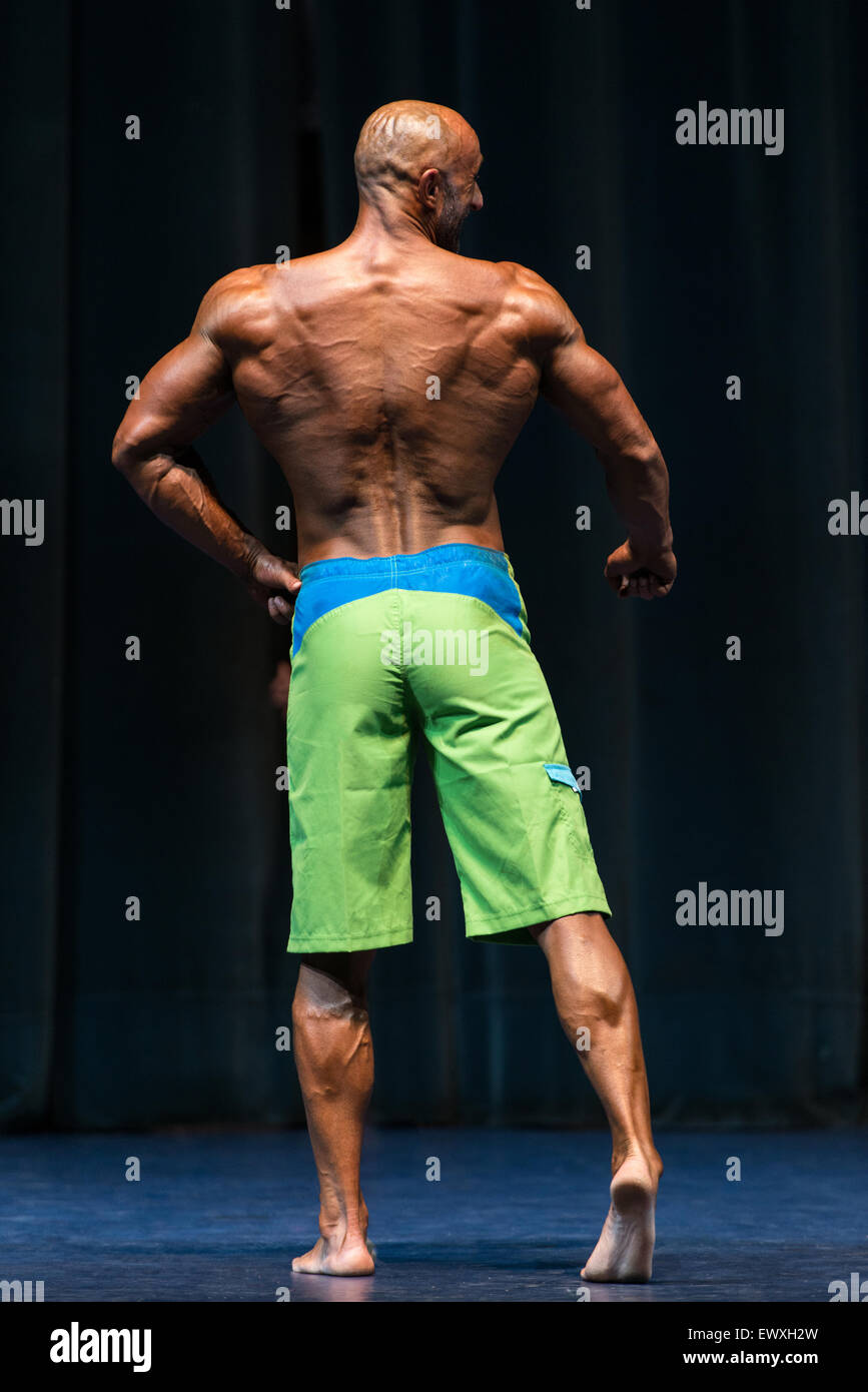 Bodybuilder On A competition For The Win - Back Poses Stock Photo - Alamy