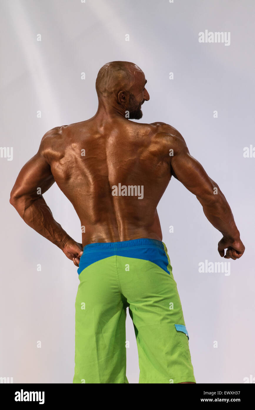 Bodybuilder On A competition For The Win - Back Poses Stock Photo - Alamy