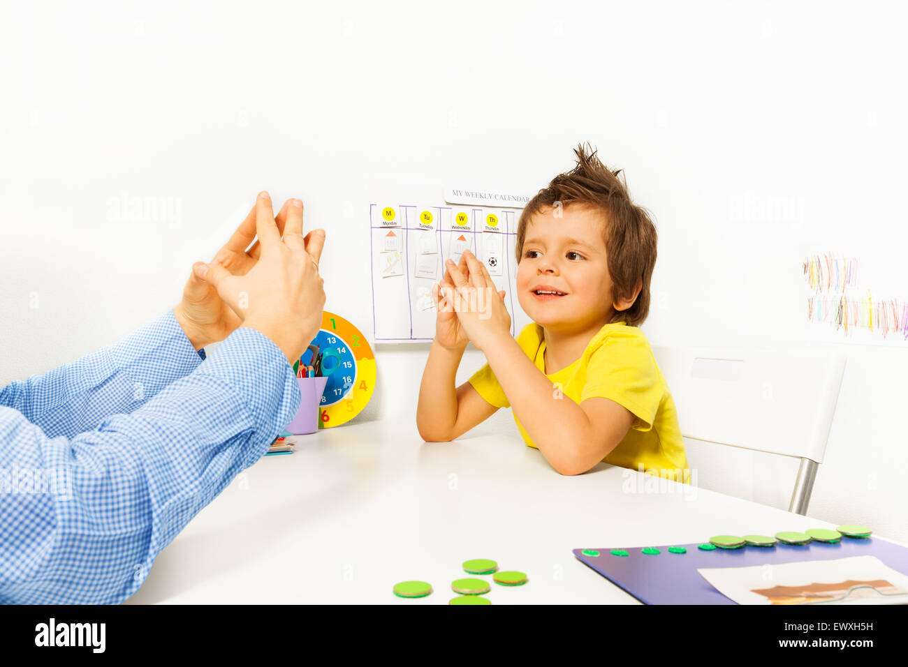 Smiling boy exercises improving motor skills Stock Photo - Alamy