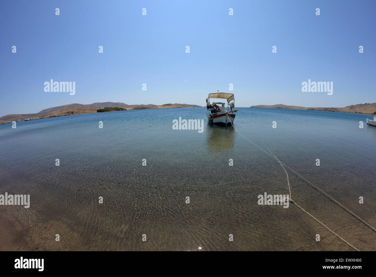 Wooden boat floating in the limpid sea of Diapori/ Kontias bay beach ...