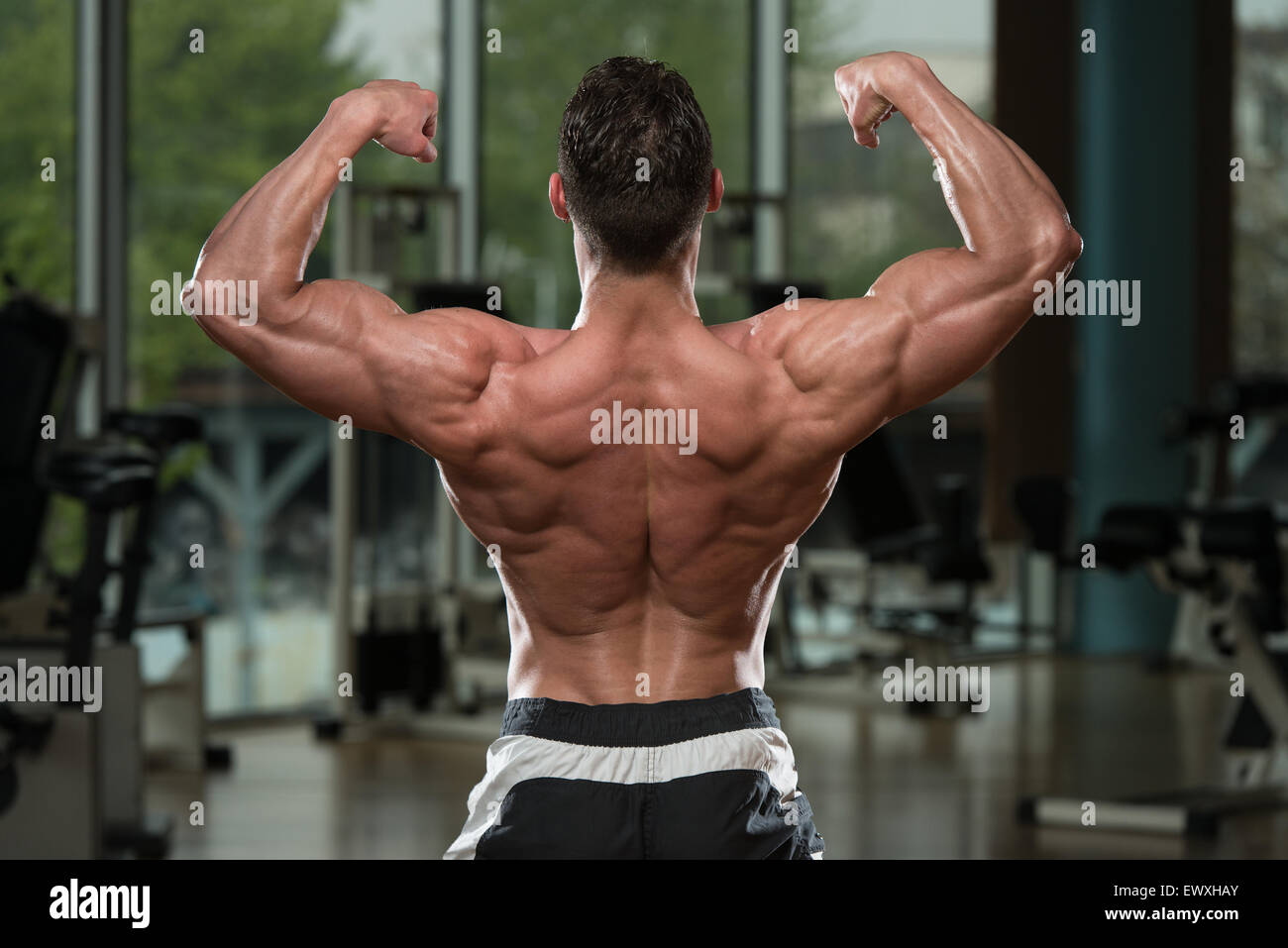 Body Builder Performing Rear Double Biceps Pose Stock Photo - Alamy