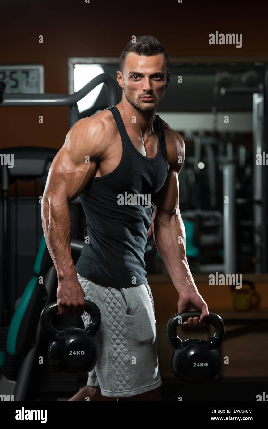 Muscular Man Exercise With Kettle Bell Stock Photo - Alamy