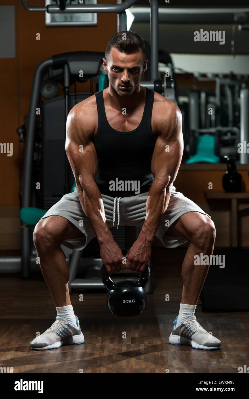 Muscular Man Exercise With Kettle Bell Stock Photo - Alamy