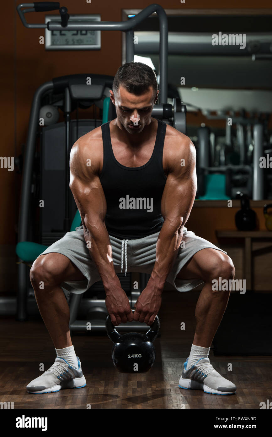 Muscular Man Exercise With Kettle Bell Stock Photo - Alamy