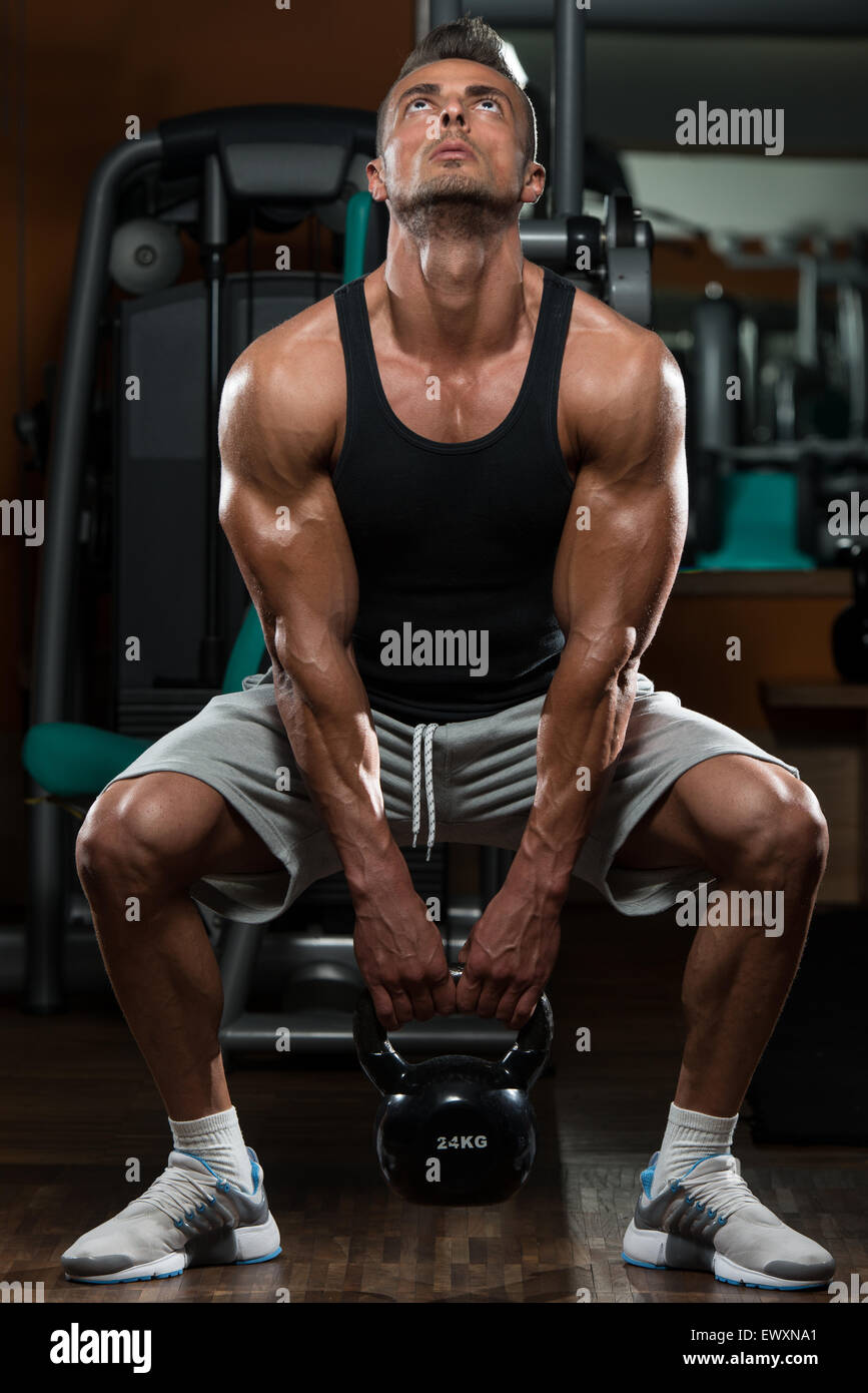 Muscular Man Exercise With Kettle Bell Stock Photo - Alamy