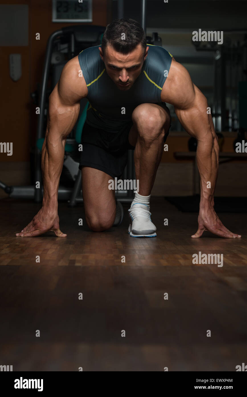 Strong Muscular Men Kneeling On The Floor - Almost Like Sprinter ...