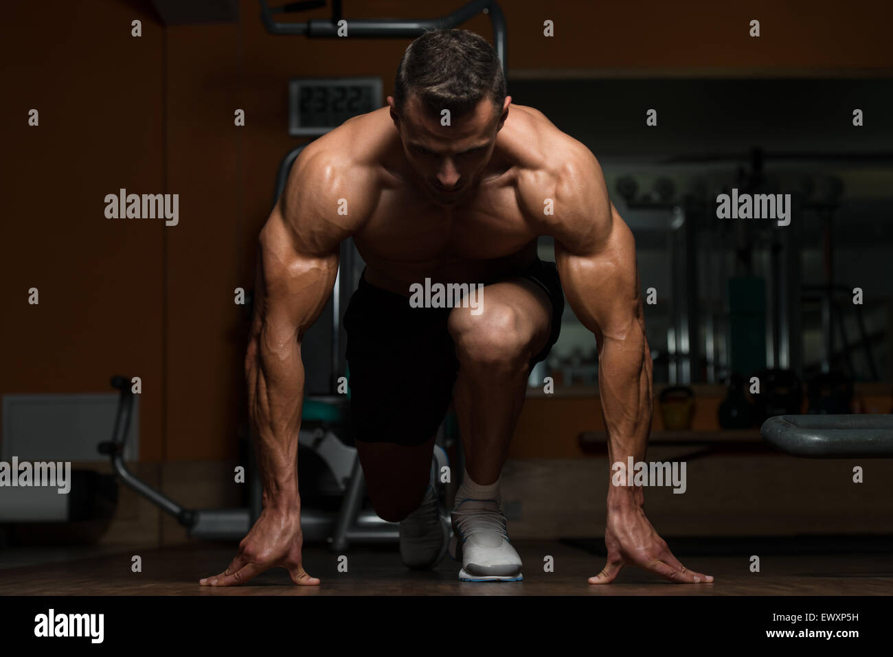 Strong Muscular Men Kneeling On The Floor - Almost Like Sprinter ...