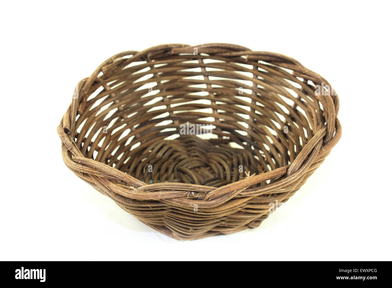 braided wicker basket against a bright background Stock Photo - Alamy