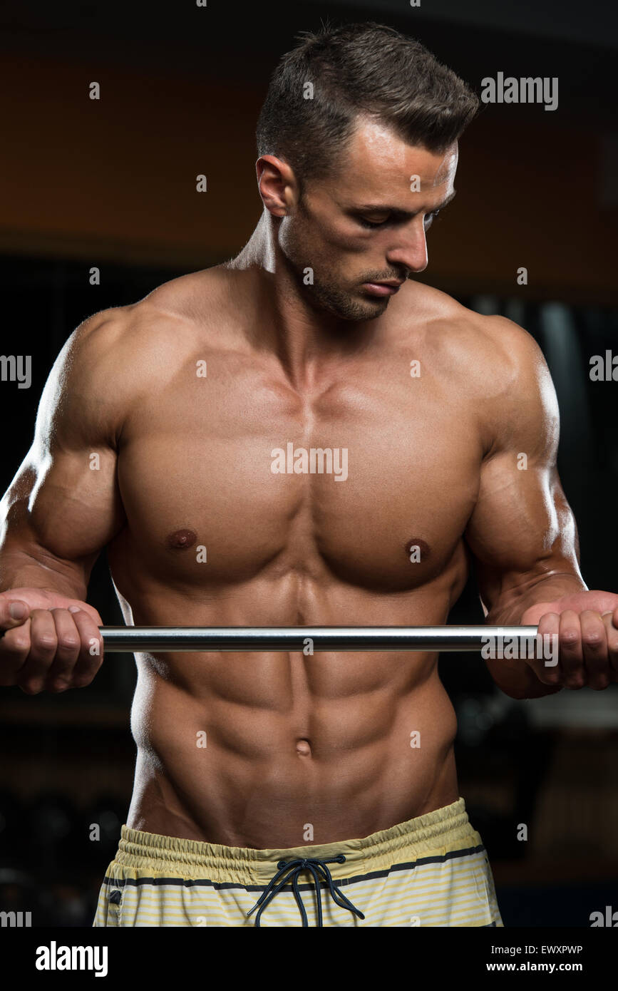 Muscular Man Doing Heavy Weight Exercise For Biceps Stock Photo - Alamy