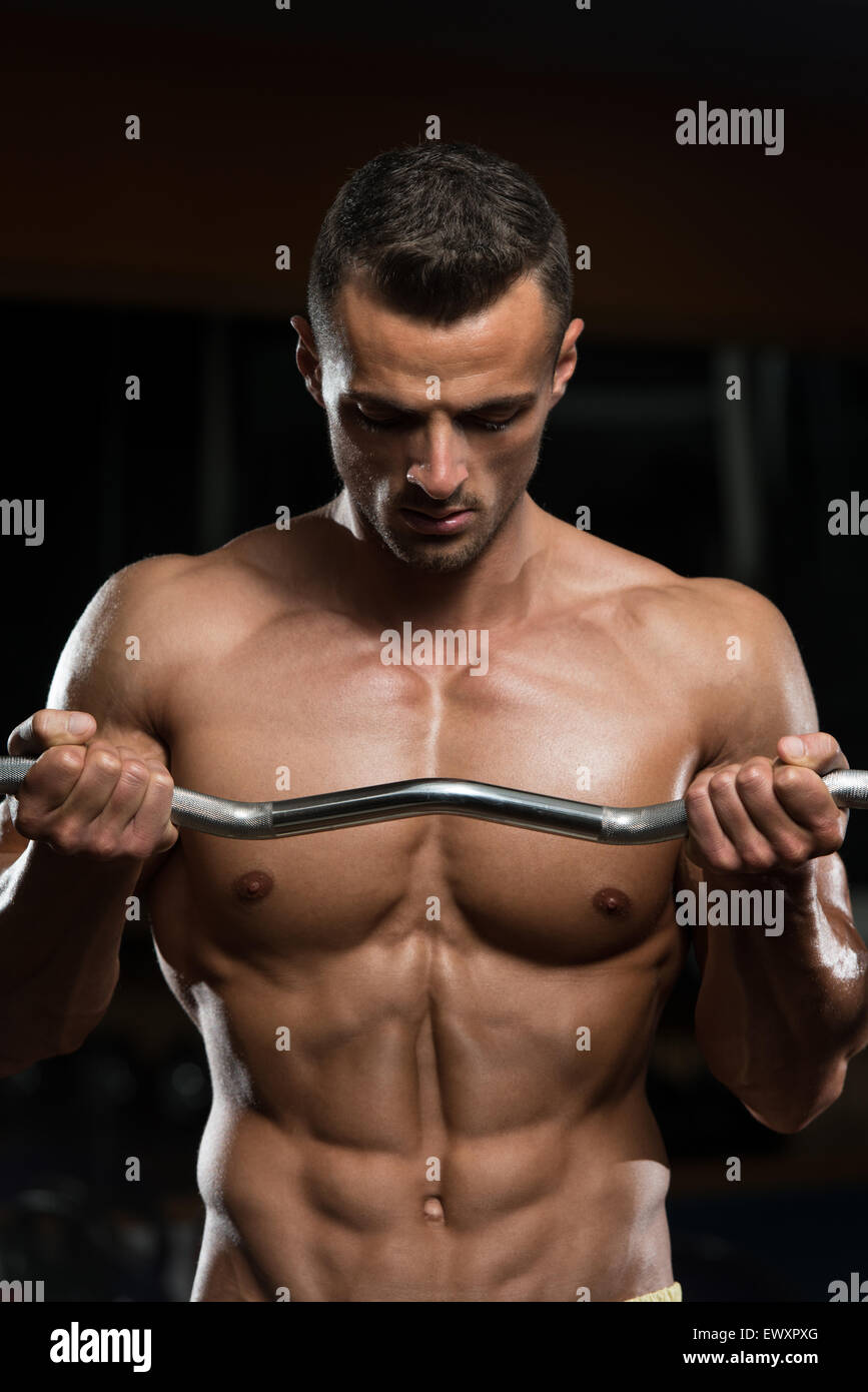 Muscular Man Doing Heavy Weight Exercise For Biceps Stock Photo - Alamy