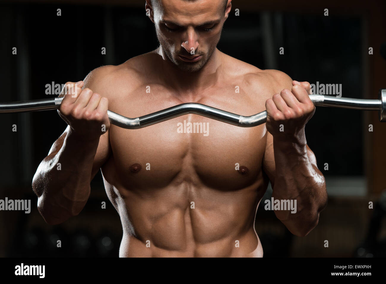 Muscular Man Doing Heavy Weight Exercise For Biceps Stock Photo - Alamy