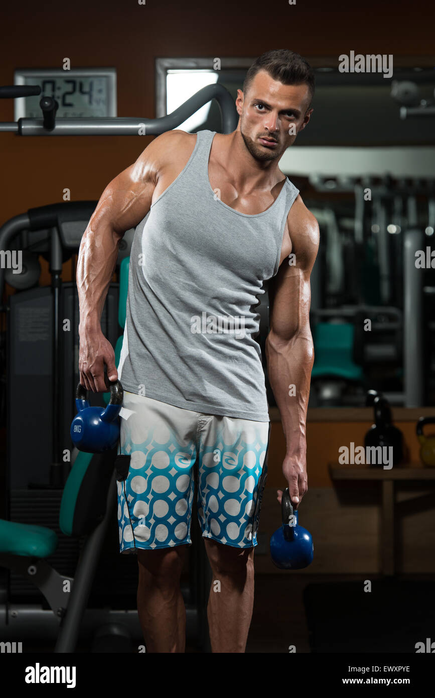 Muscular Man Exercise With Kettle Bell Stock Photo - Alamy