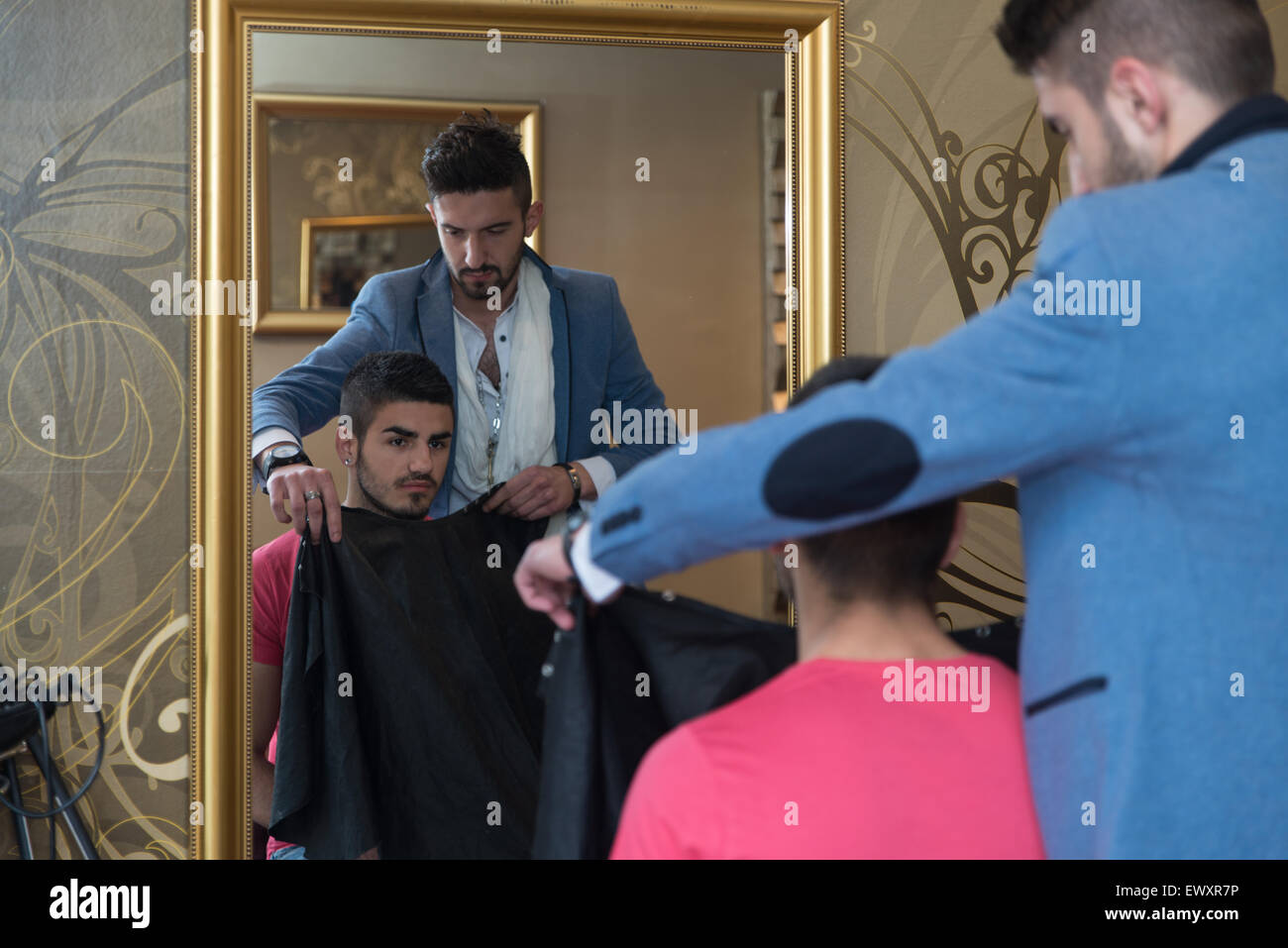 Handsome Young Hairdresser Giving A New Haircut To Male Customer At ...