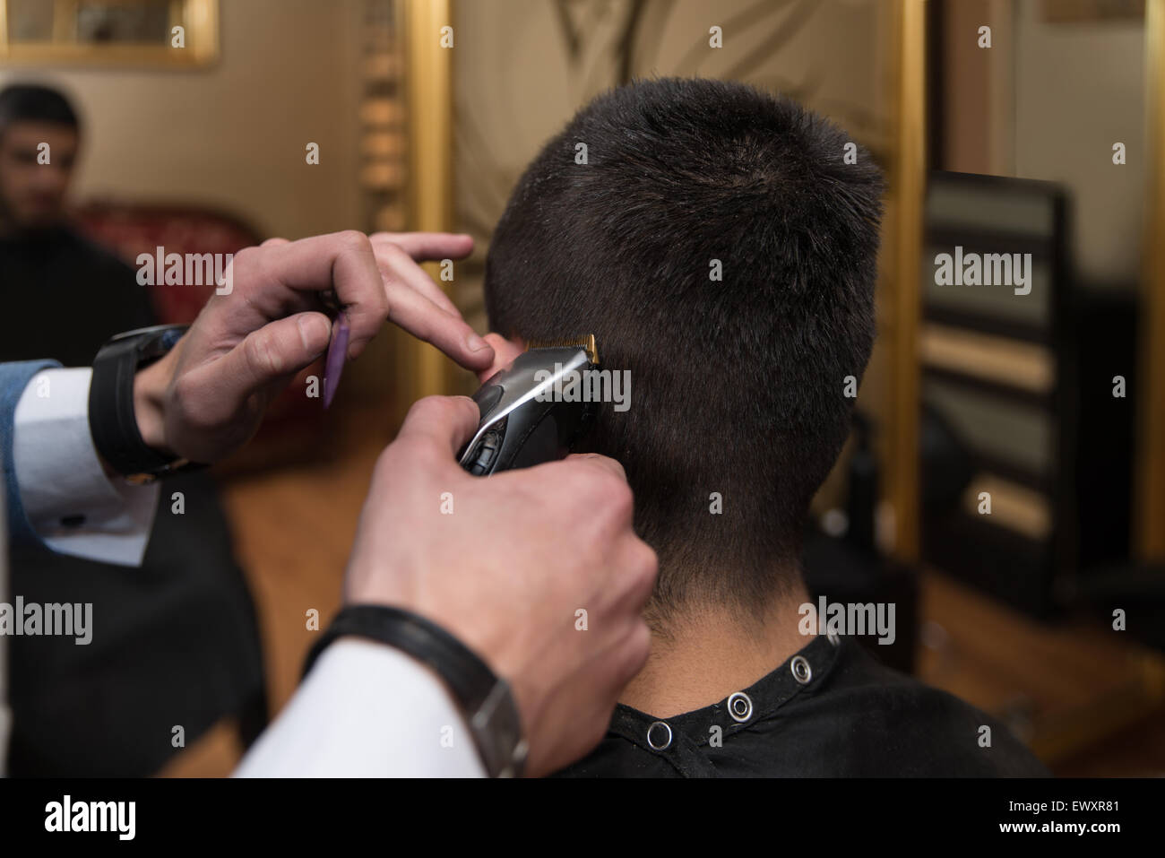 Handsome Young Hairdresser Giving A New Haircut To Male Customer At ...