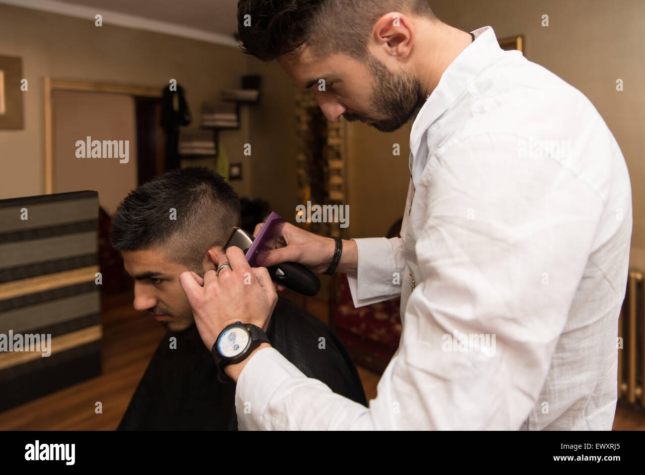 Handsome Young Hairdresser Giving A New Haircut To Male Customer At ...
