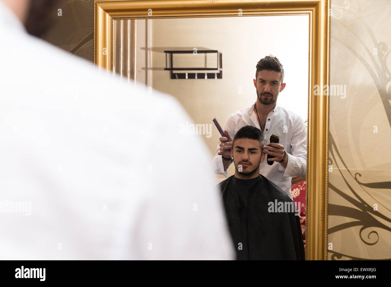 Handsome Young Hairdresser Giving A New Haircut To Male Customer At ...