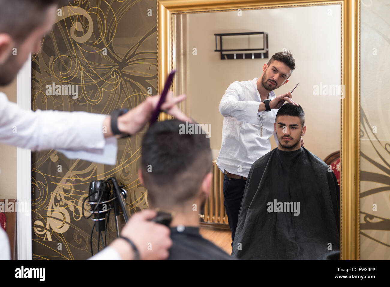Handsome Young Hairdresser Giving A New Haircut To Male Customer At ...