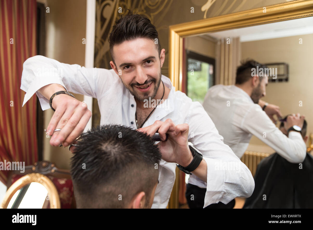 Handsome Young Hairdresser Giving A New Haircut To Male Customer At ...