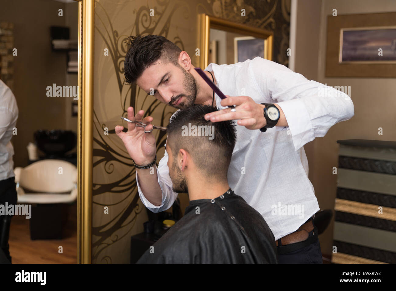 Handsome Young Hairdresser Giving A New Haircut To Male Customer At ...