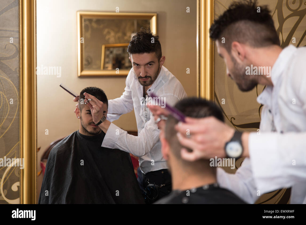 Handsome Young Hairdresser Giving A New Haircut To Male Customer At ...