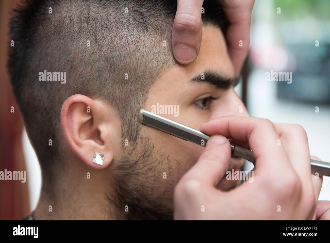 Handsome Young Hairdresser Giving A New Haircut To Male Customer At ...