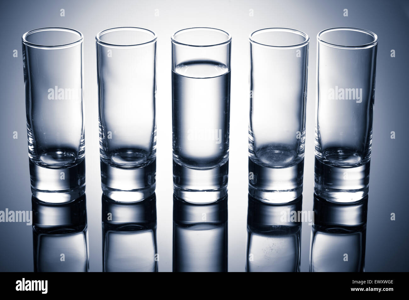 row of glasses for vodka Stock Photo - Alamy