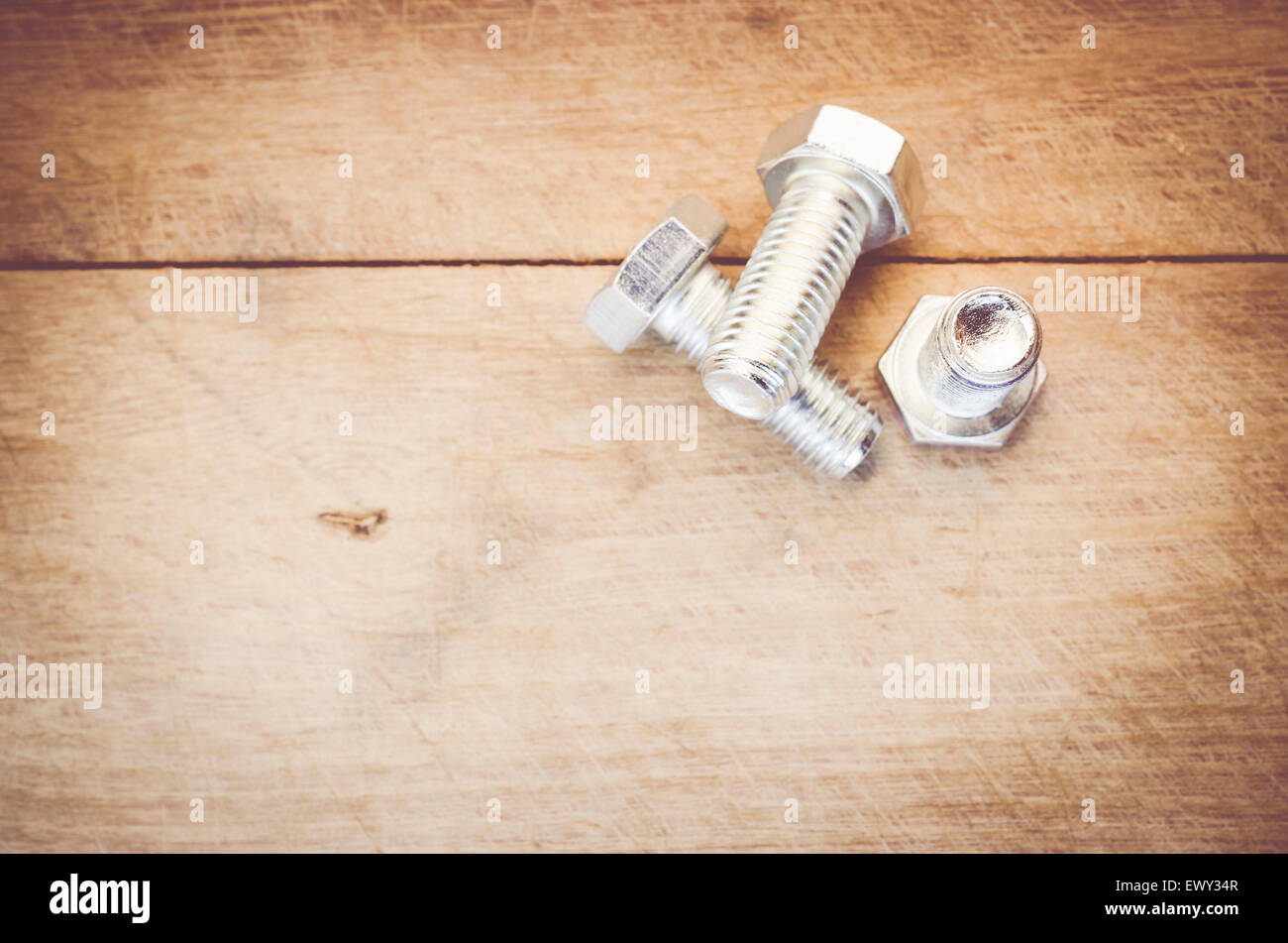shiny galvanized metal bolts on a natural wood surface Stock Photo - Alamy