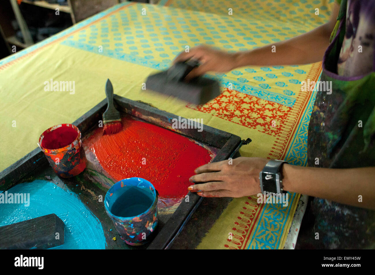 DHAKA, BANGLADESH 2nd July : Worker coloring on a clothe to sale ahead ...