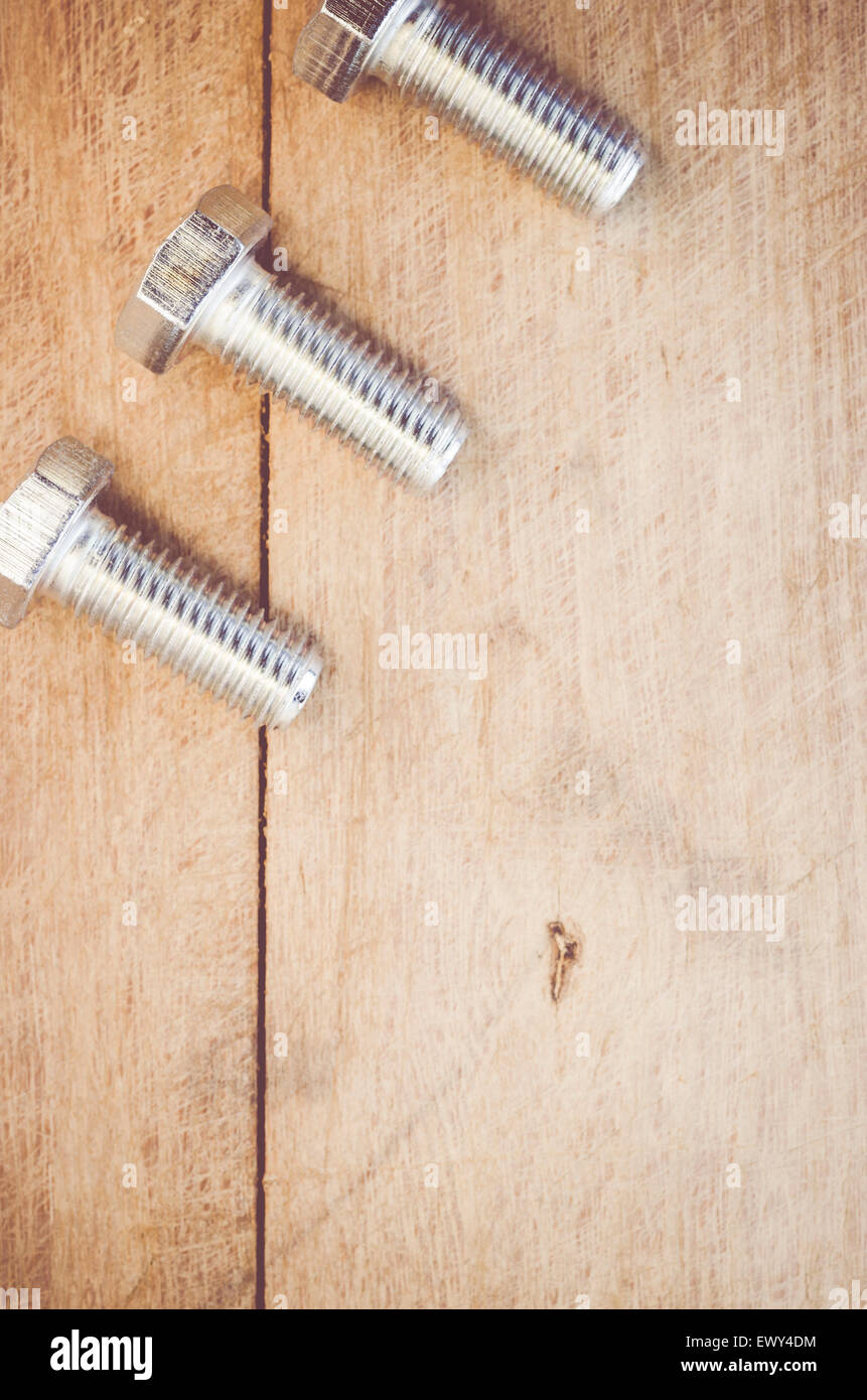 shiny galvanized metal bolts on a natural wood surface Stock Photo - Alamy