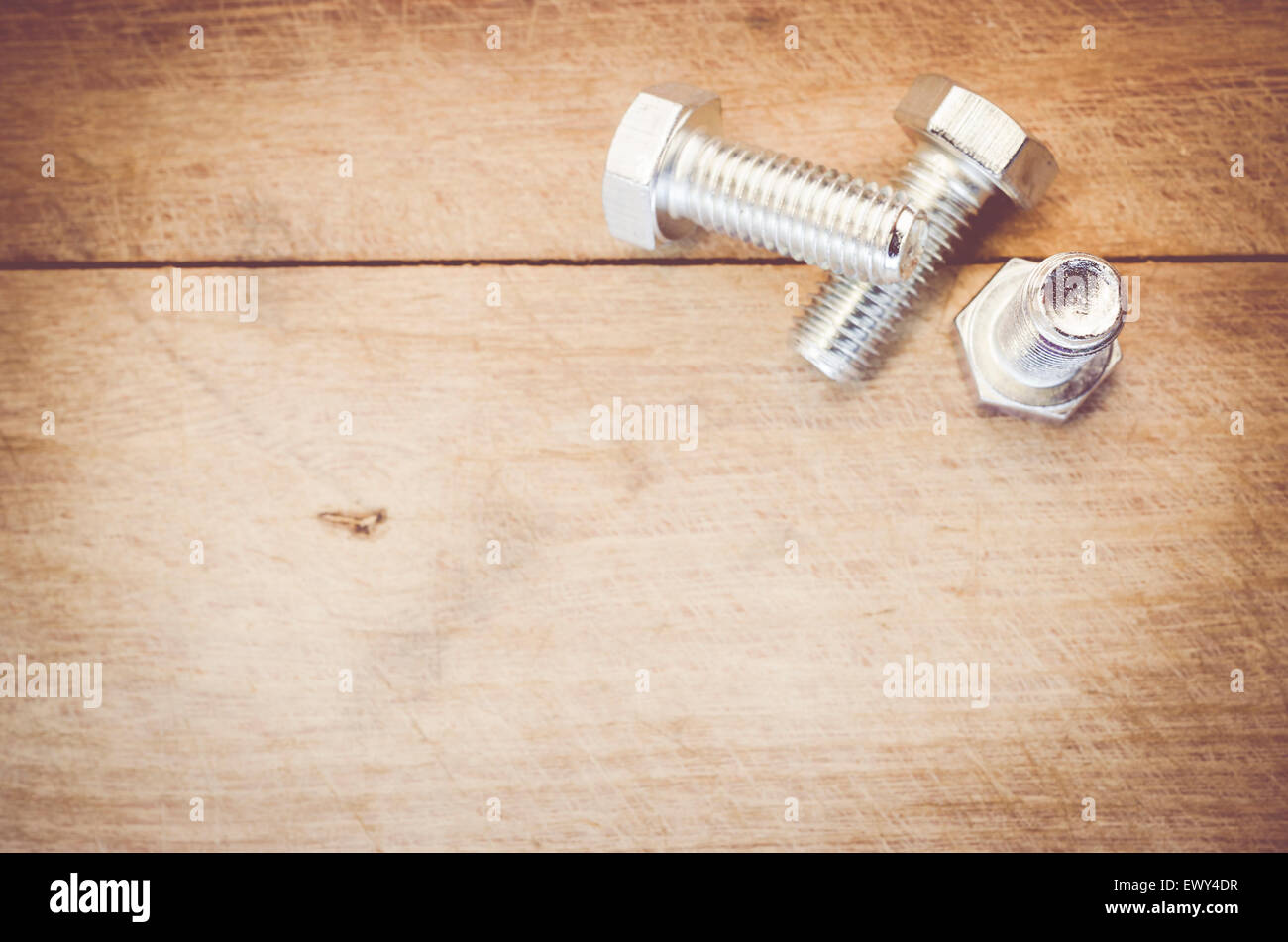 shiny galvanized metal bolts on a natural wood surface Stock Photo - Alamy