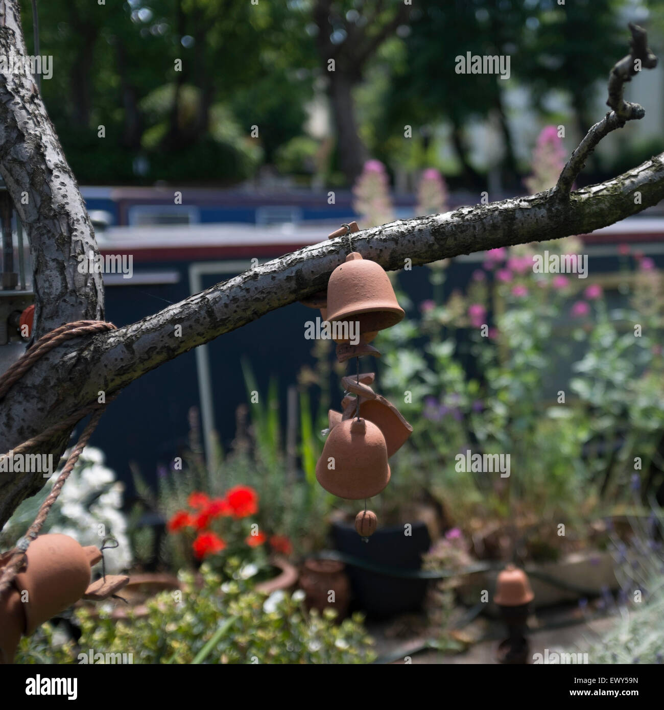 Ceramic wind chime hanging on a tree branch Stock Photo - Alamy