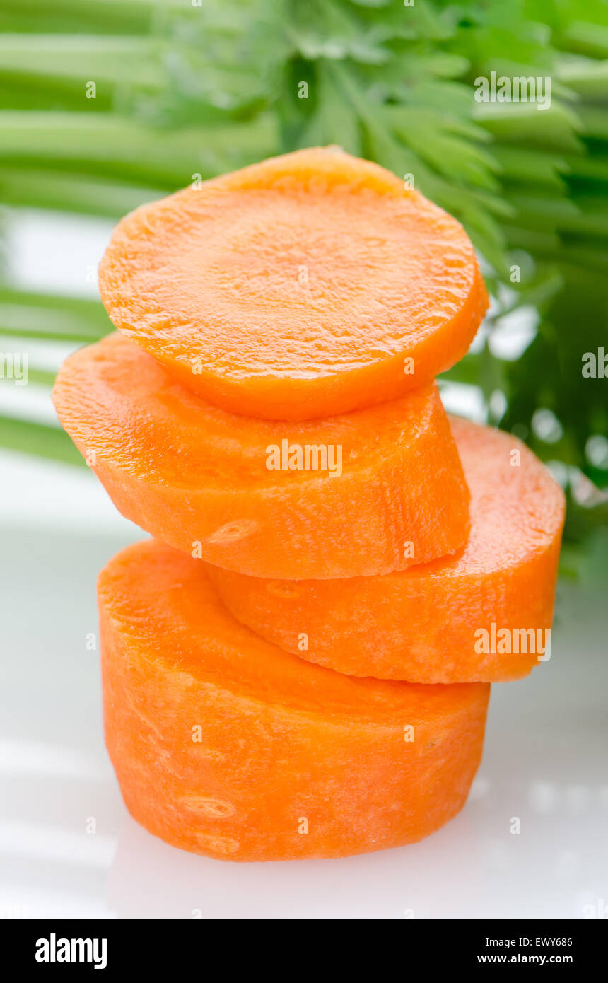 Pile of carrot slices closeup on white reflective background Stock ...