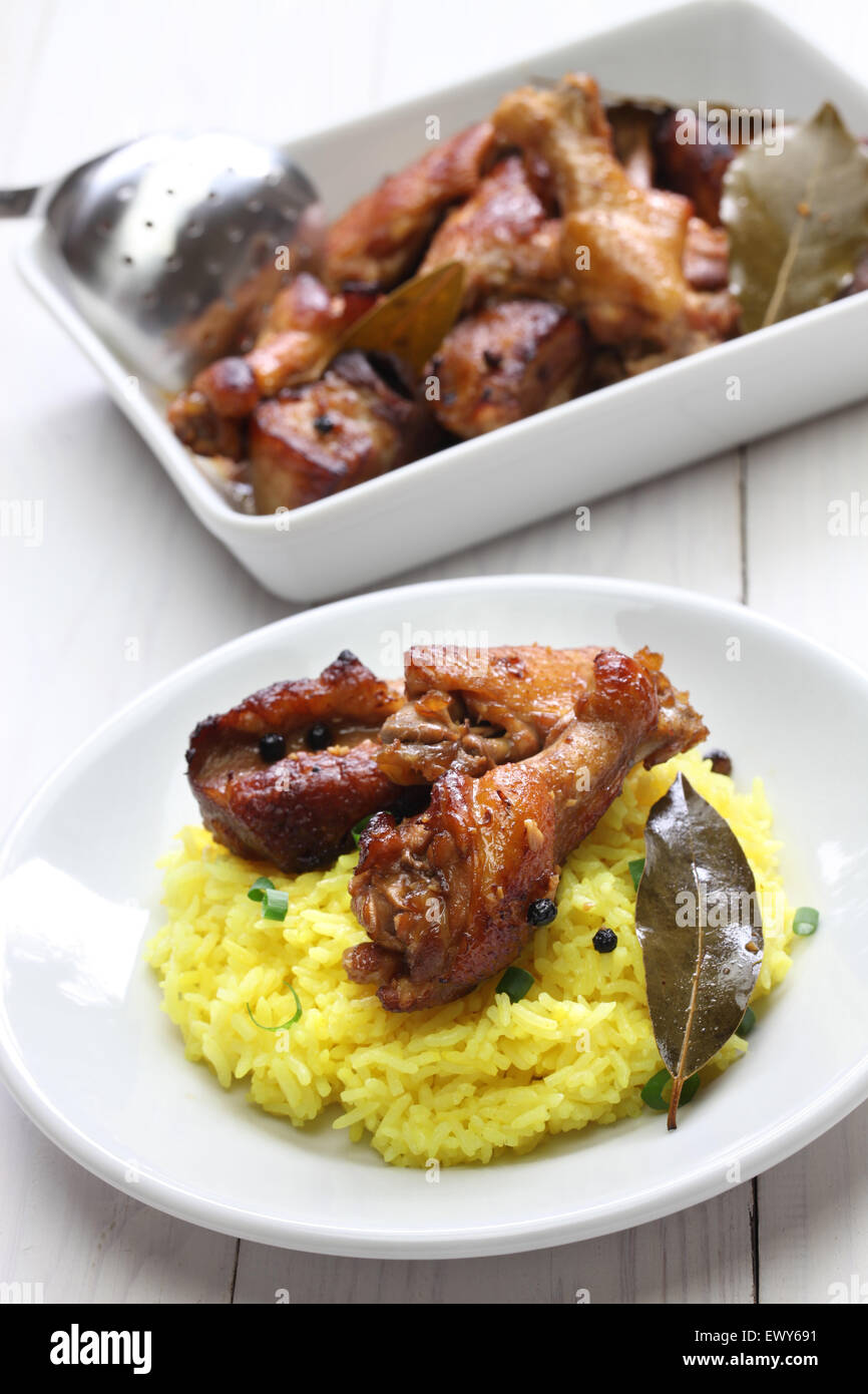chicken and pork adobo over yellow rice, filipino food Stock Photo - Alamy