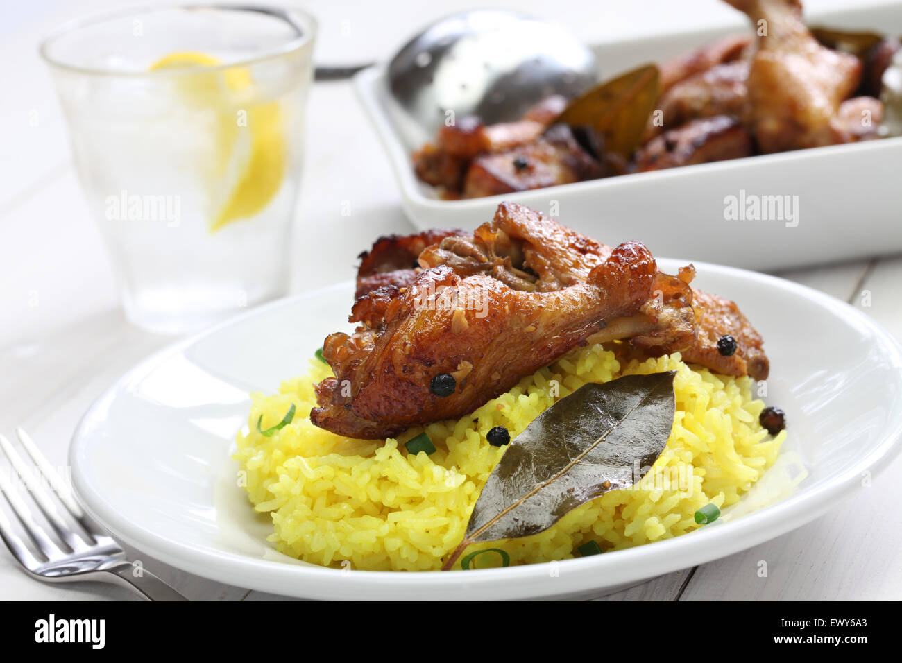 chicken and pork adobo over yellow rice, filipino food Stock Photo - Alamy
