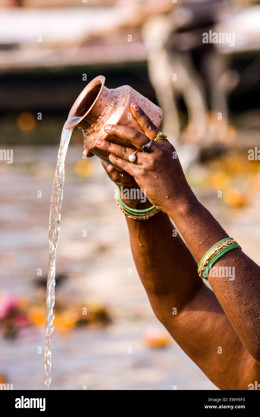 Hindu woman immersed in the holy, but polluted, Ganges water, raises ...