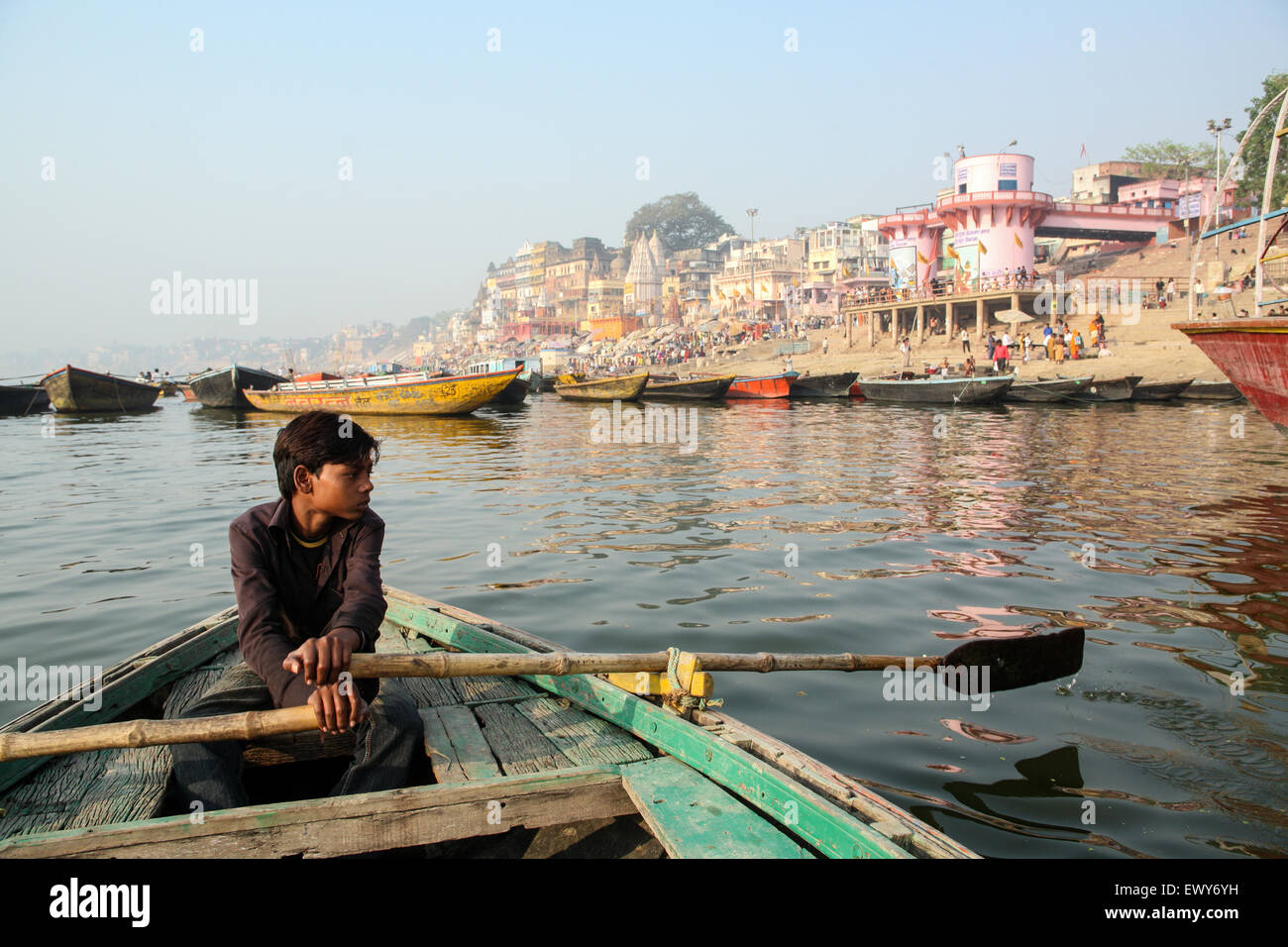 Boy rowing boat for tourists along River Ganges. The culture of ...