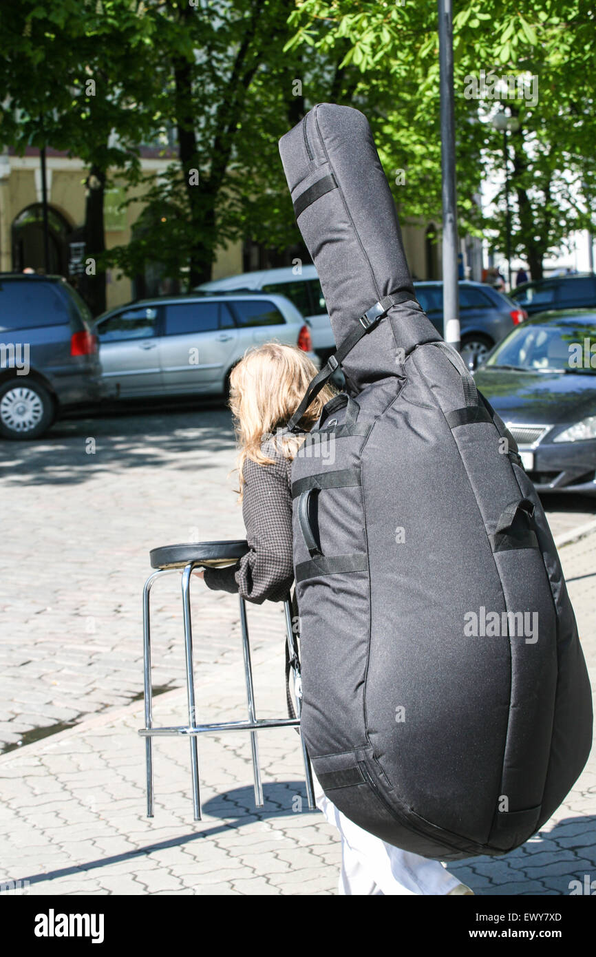 Local musician carrying a large musical instrument to her next ...