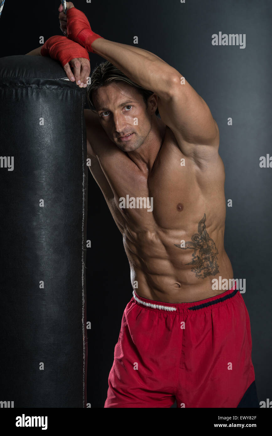 A Man With A Tattoo In Red Boxing Gloves - Boxing On Black Background ...