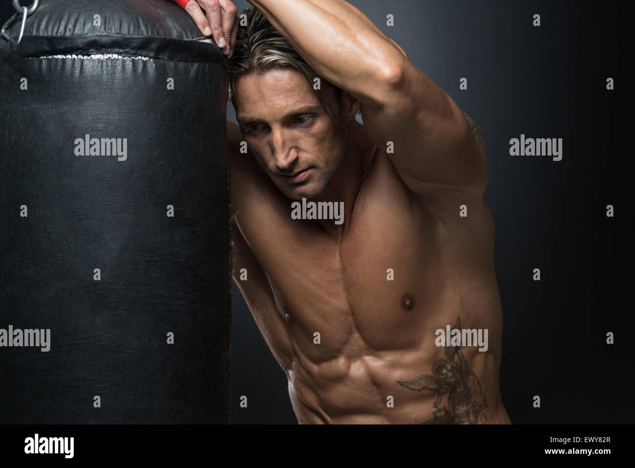 A Man With A Tattoo In Red Boxing Gloves - Boxing On Black Background ...