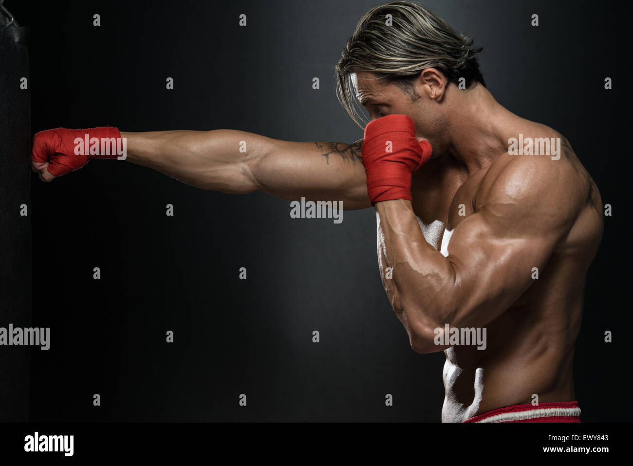 A Man With A Tattoo In Red Boxing Gloves - Boxing On Black Background ...